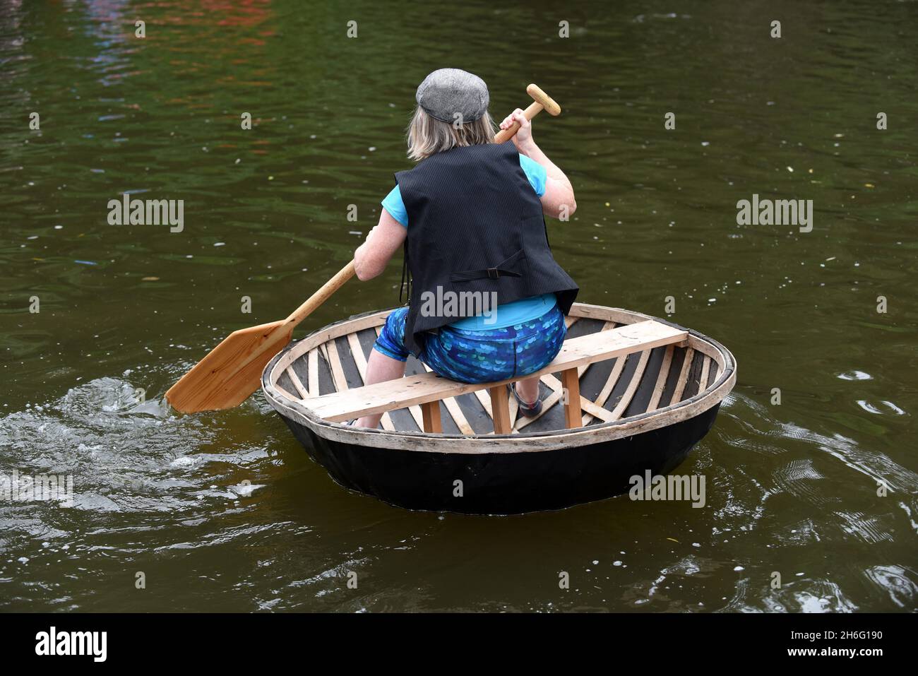 Woman lady paddling a coracle Ironbridge Coracle Regatta. August 2021 ...