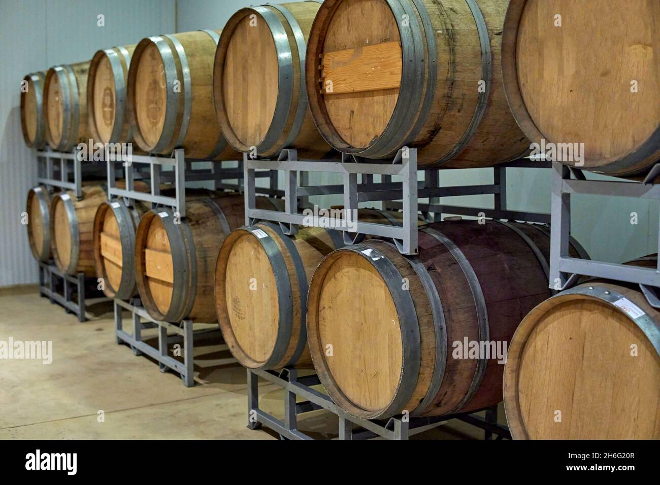 Wooden barrels of wine in a row inside a winery in Cordoba Argentina ...