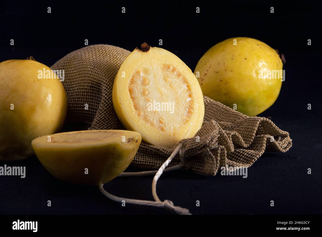 Yellow guava on black background, still life style. Healthy diet Stock ...