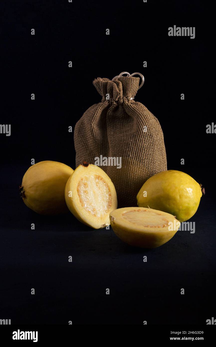 Yellow guava on black background, still life style. Healthy diet Stock ...
