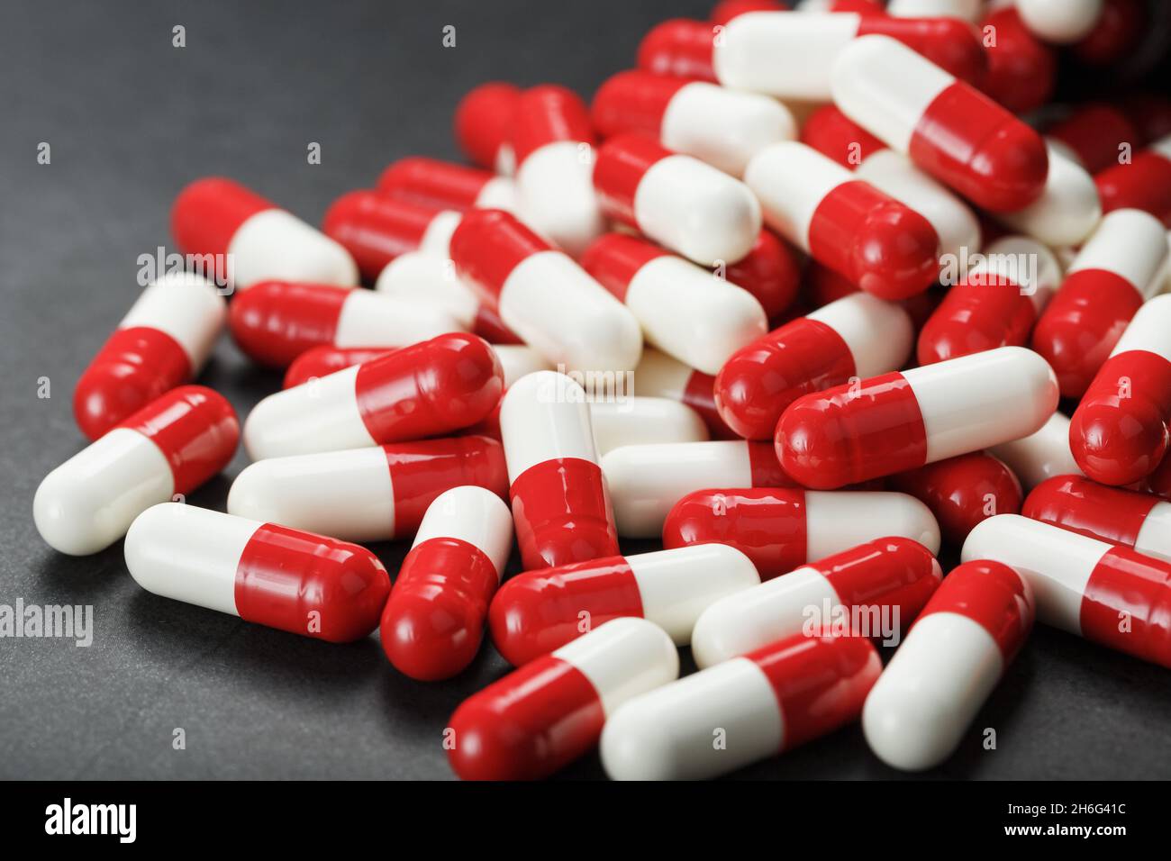 Medical red and white capsules isolated on a black background. Capsules ...