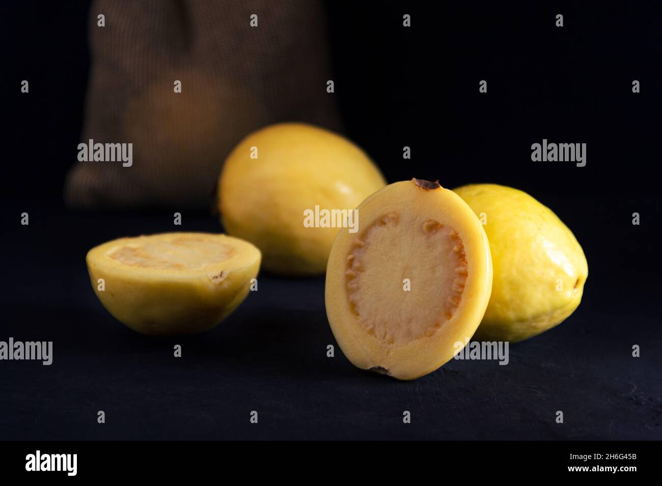 Yellow guava on black background, still life style. Healthy diet Stock ...