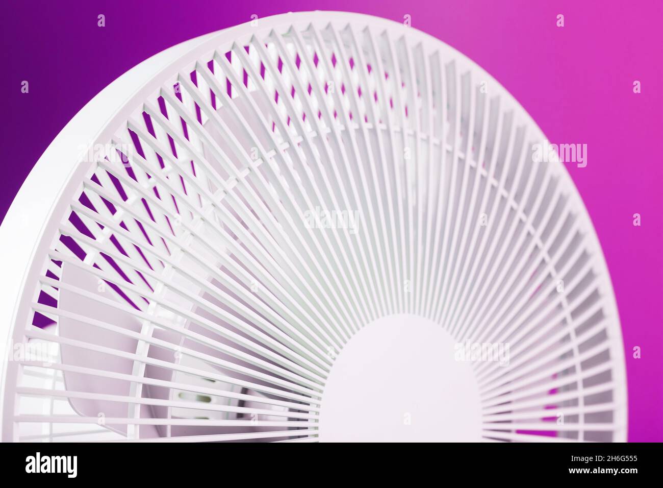 A high-tech white electric fan with a modern design for cooling the ...