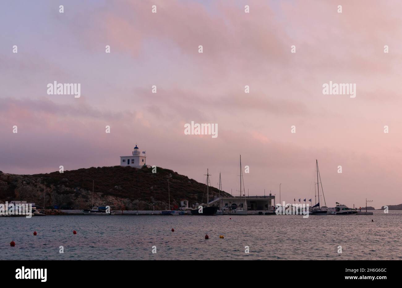 Greek Traditional Lighthouse And Pink Sunset Glow Stock Photo - Alamy