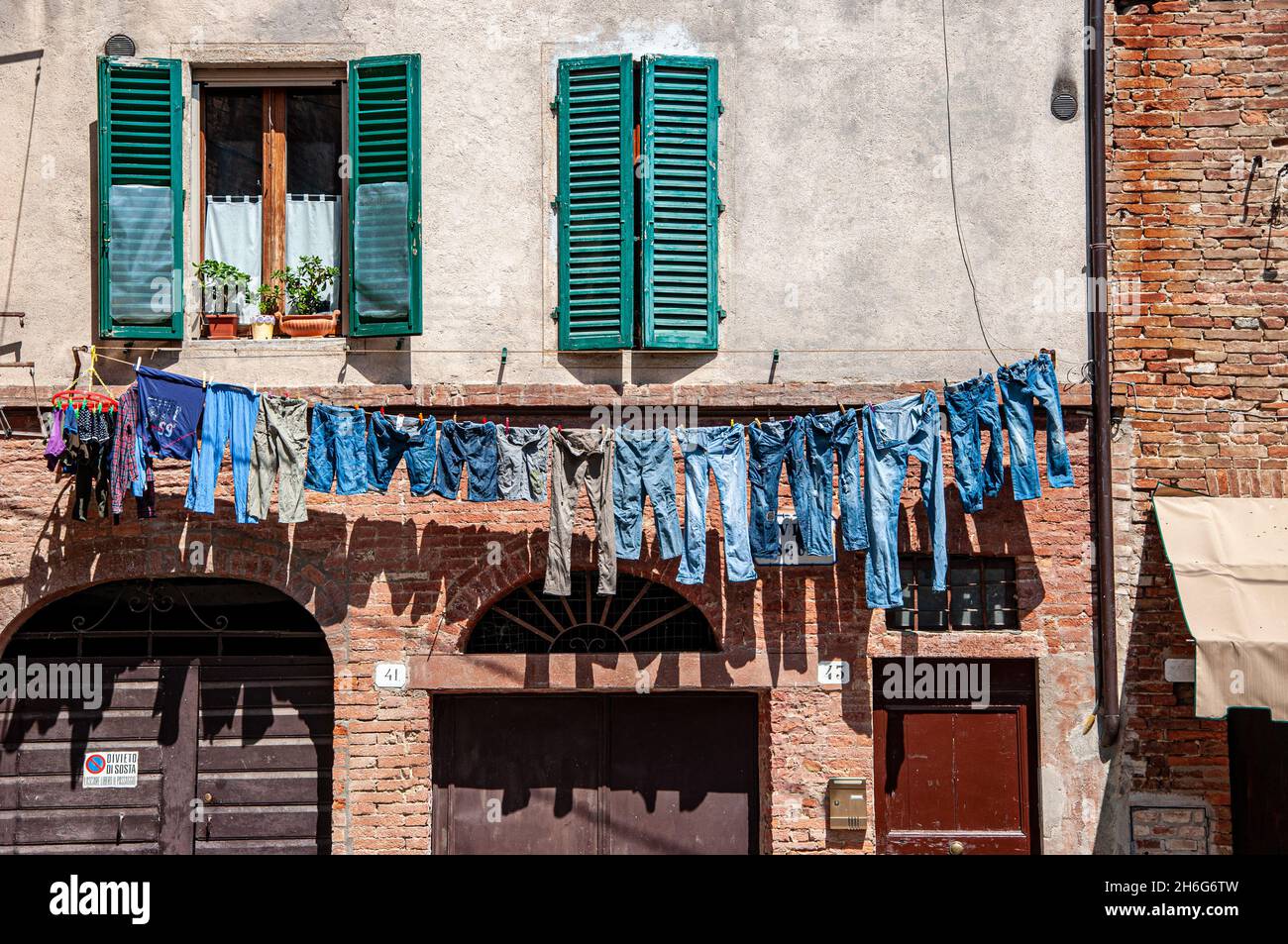 Laundry hanging on the rope on the second floor of a hous Stock Photo ...