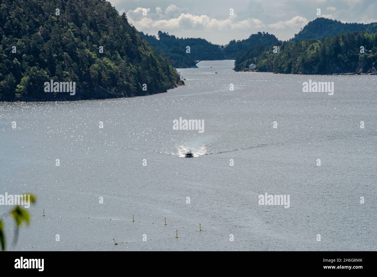 Small open boat cruising through a fjord Stock Photo - Alamy