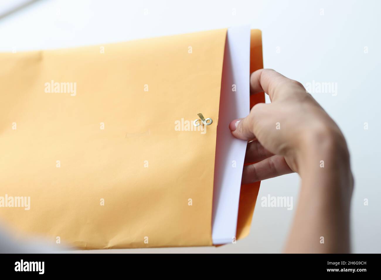 Woman hand takes out letter from envelope closeup Stock Photo - Alamy
