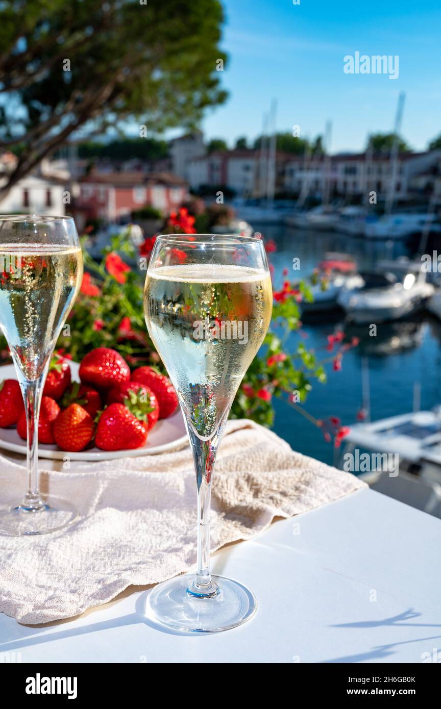 Summer party, pouring of French brut champagne sparkling wine in ...