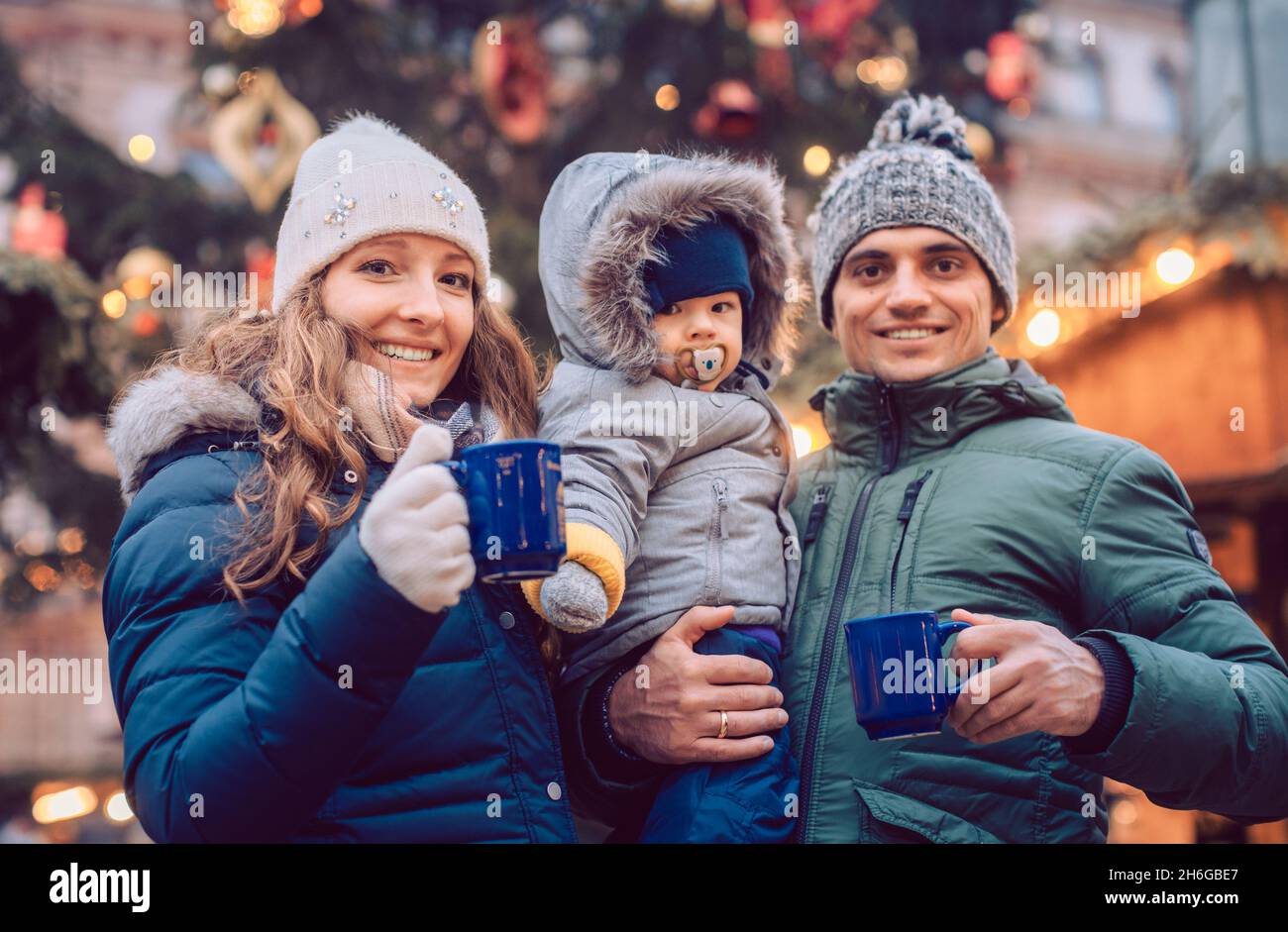 Family with child having fun at the Christmas market Stock Photo - Alamy