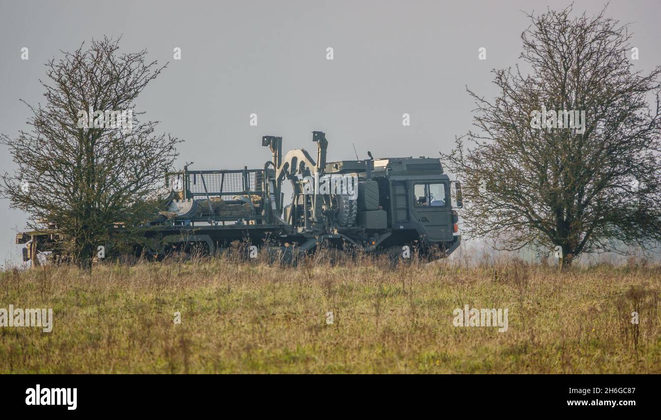 MAN SV 8x8 army logistics truck vehicle with cargo driving along a mud ...