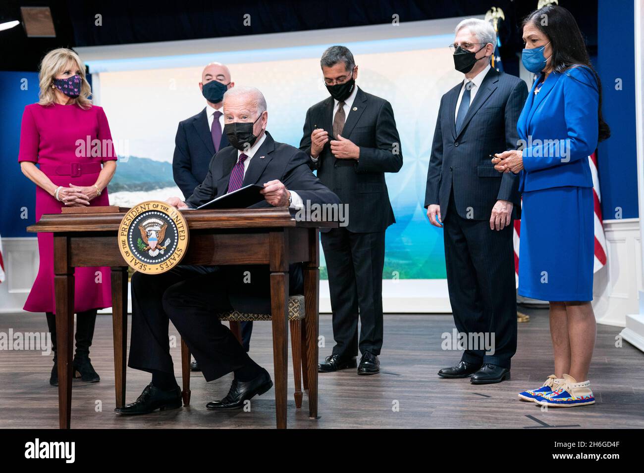 United States President Joe Biden signs an executive order to help ...