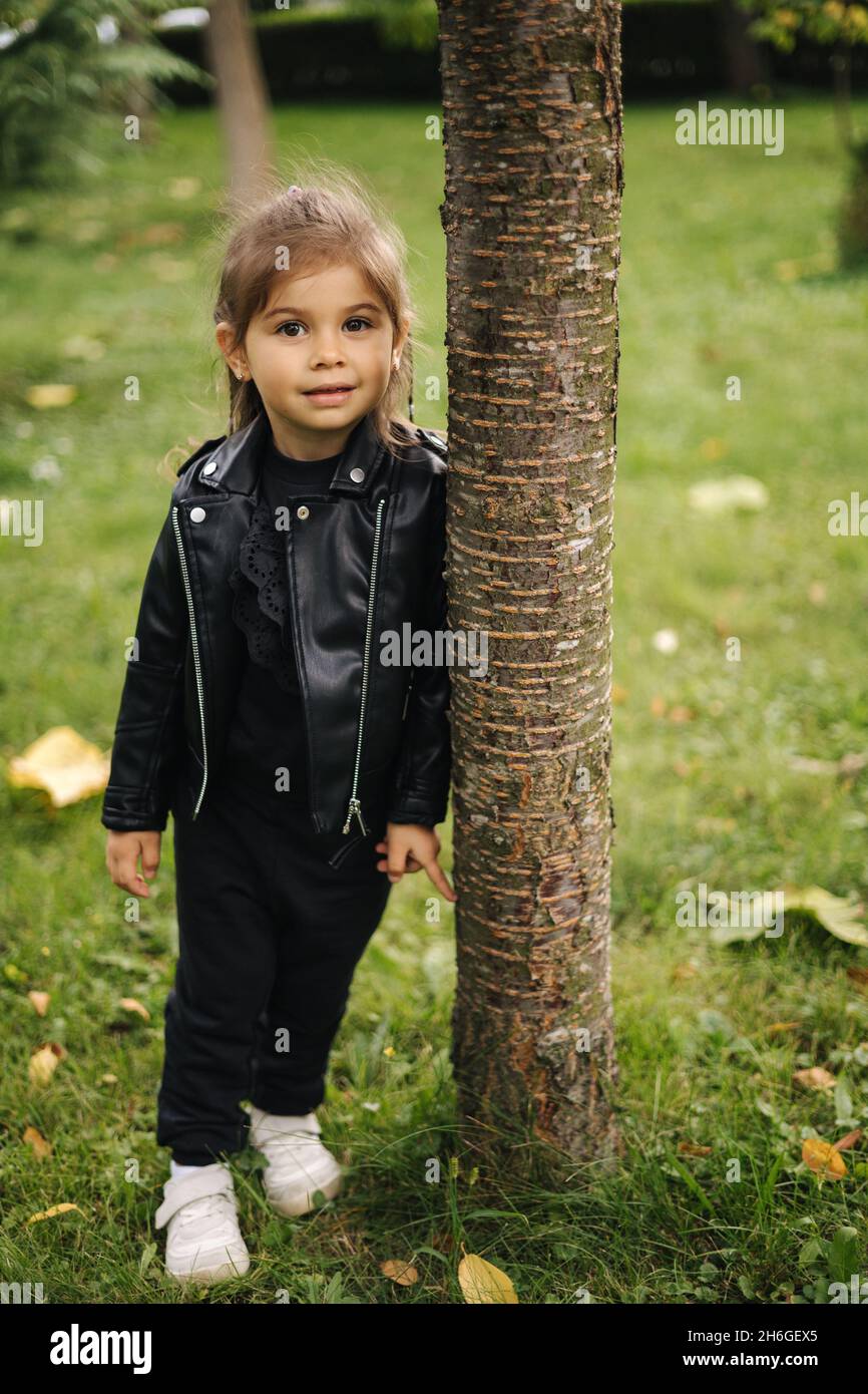 Beautiful little girl walking in the park. Happy kid outdoor. Autumn ...