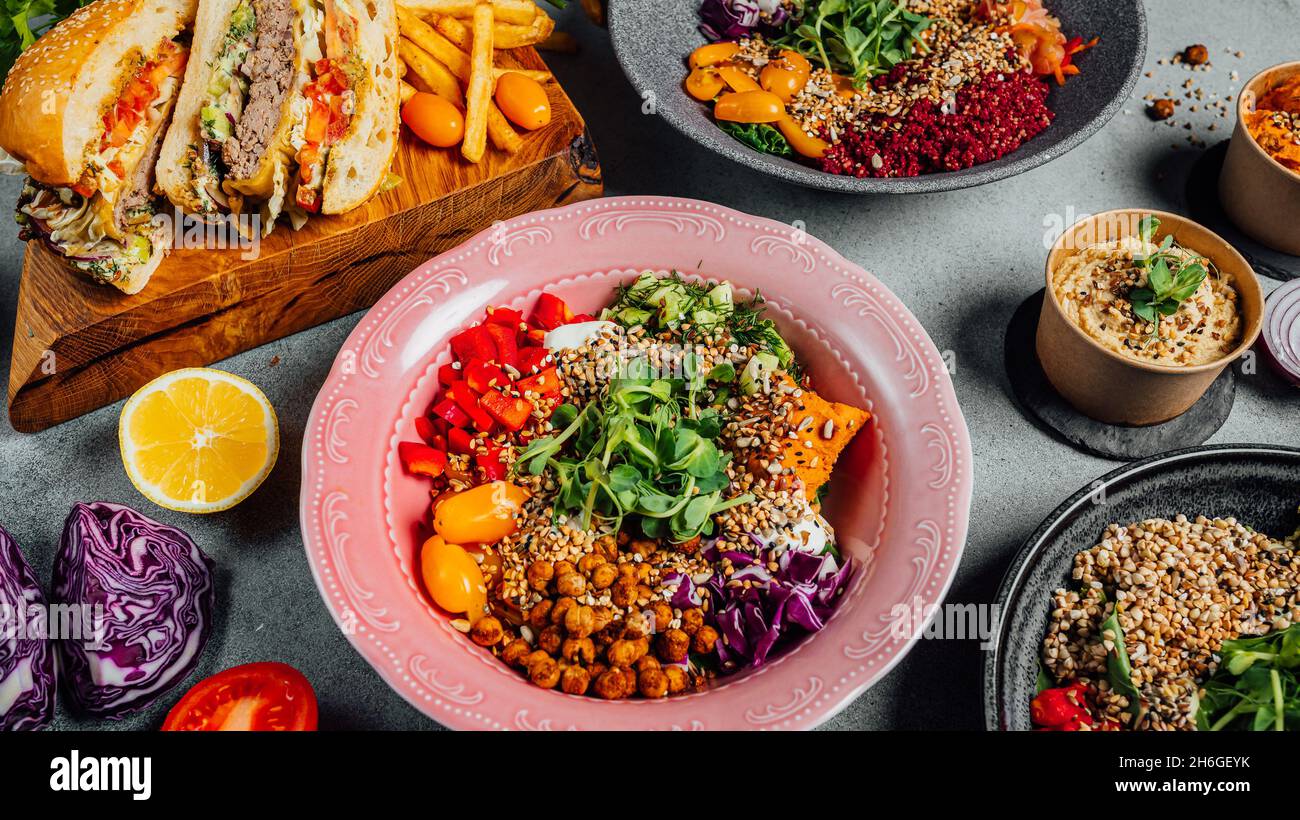 Healthy bowl, hamburger and lots of food Stock Photo - Alamy