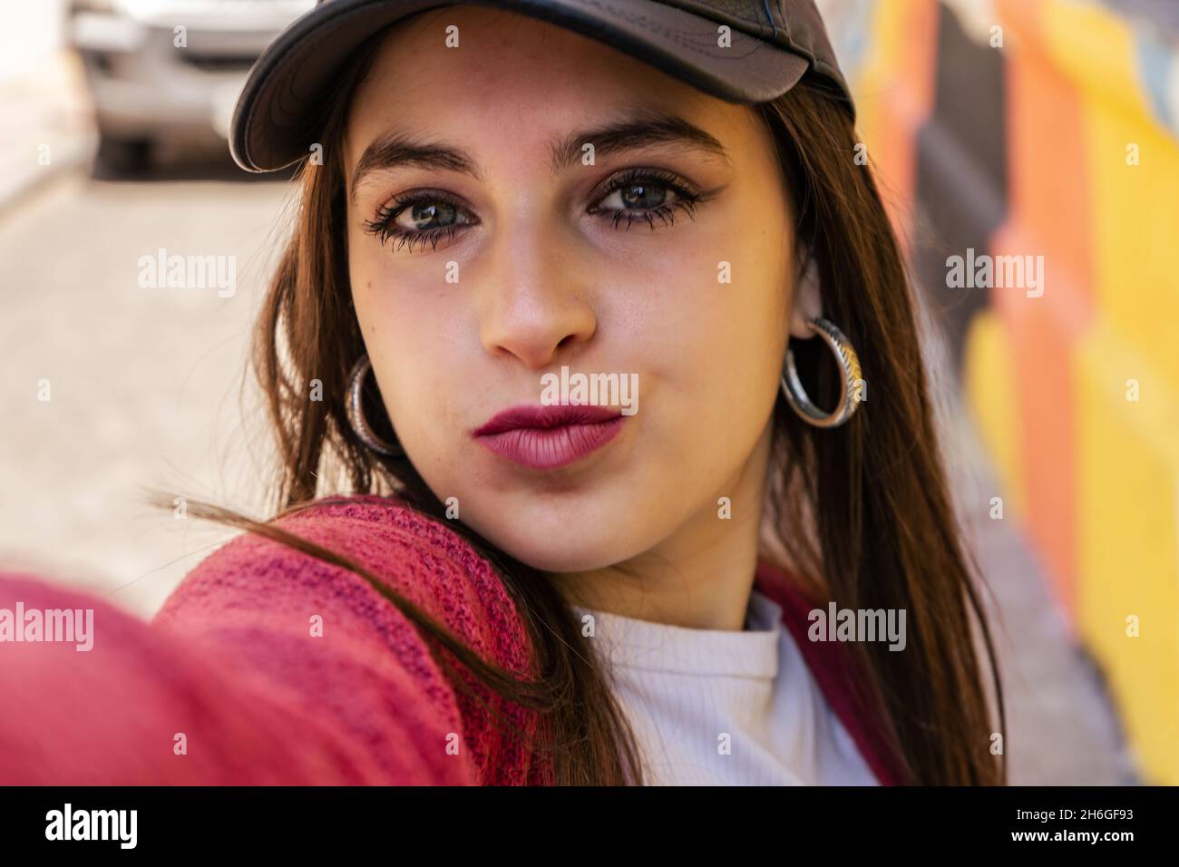 Close Up Portrait Of A Young Attractive Woman Holding A Smartphone