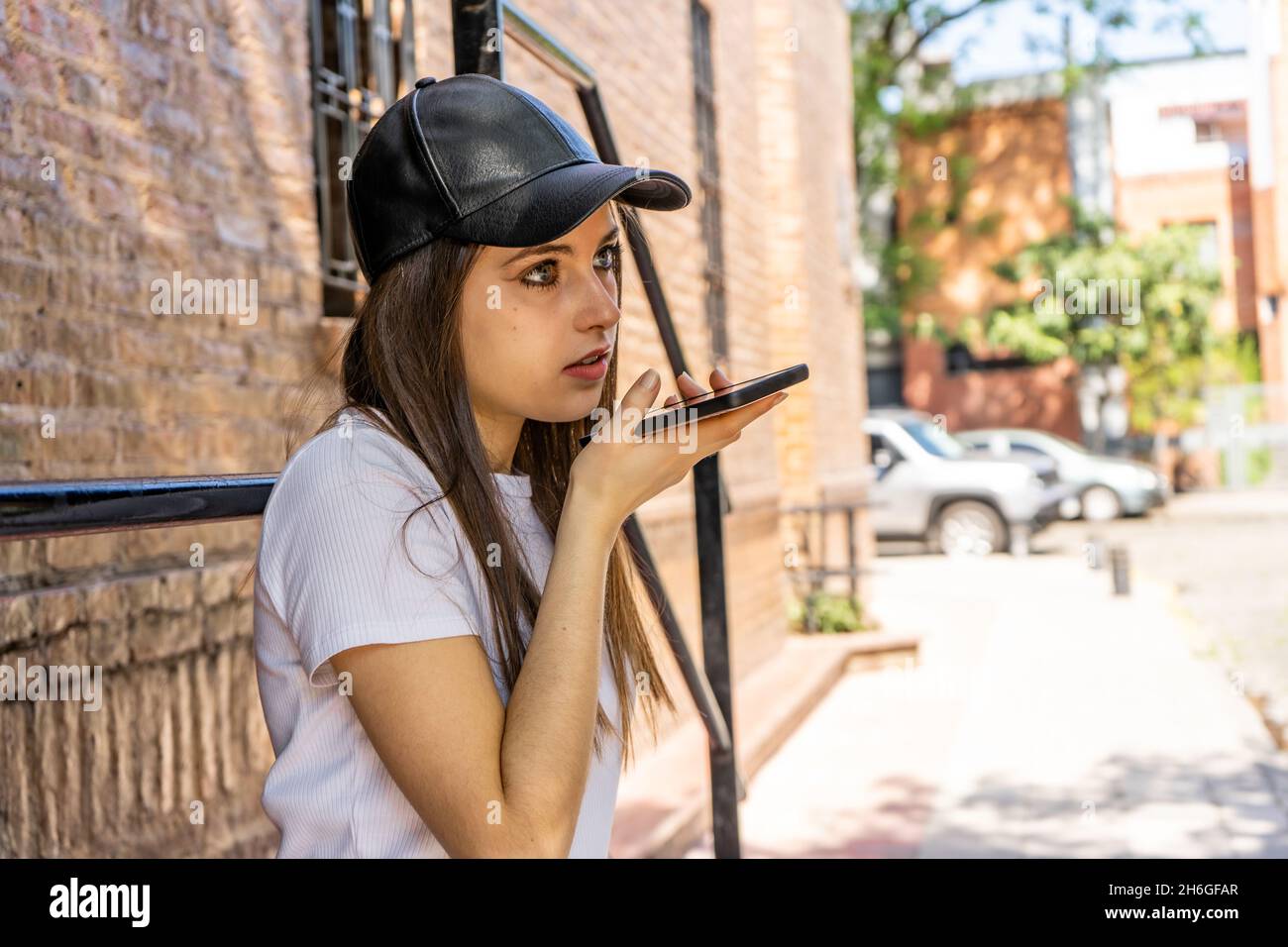 Close up woman recording voice message, speaking, young female holding ...