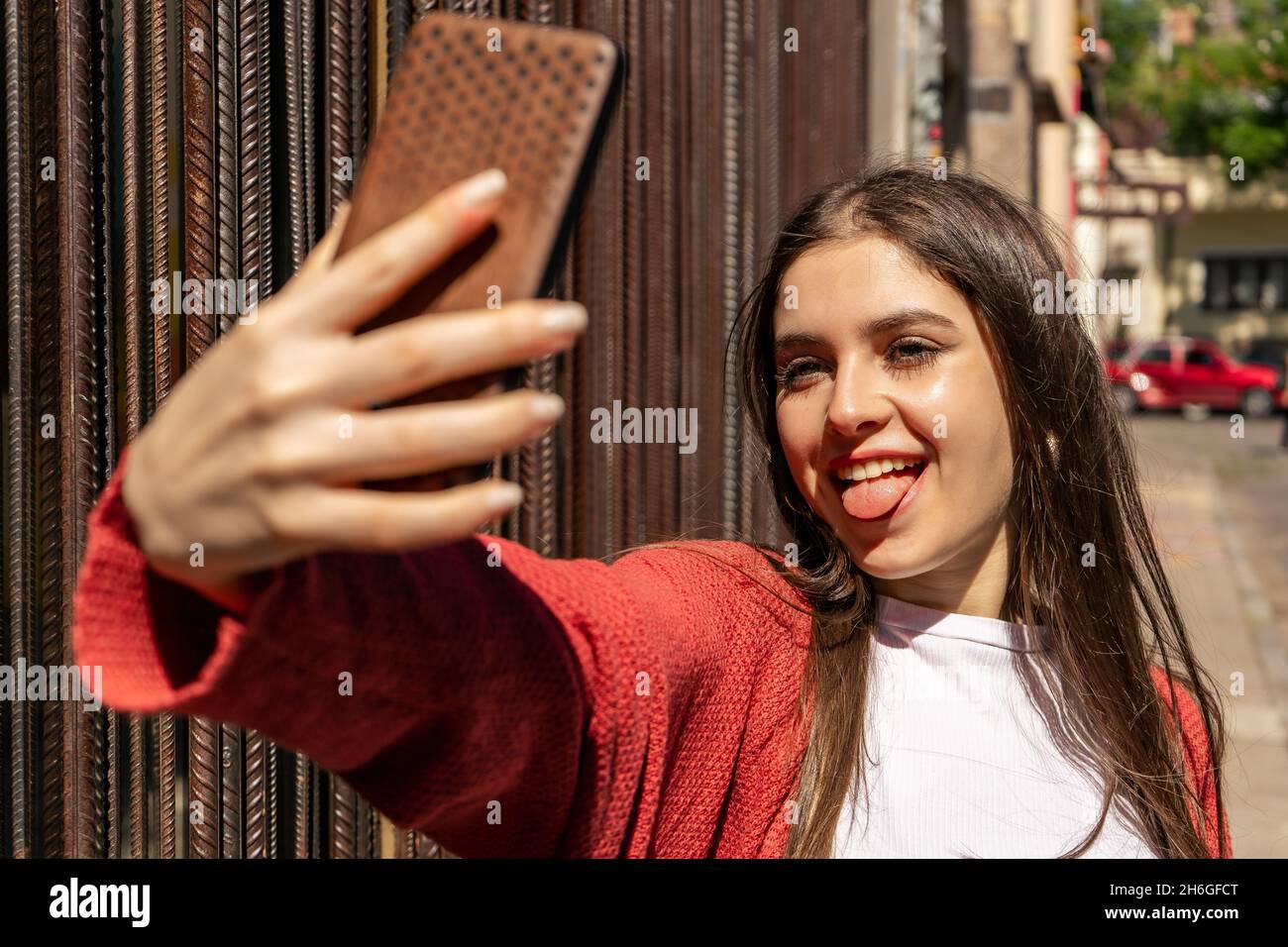 Close Up Portrait Of A Young Attractive Woman Holding A Smartphone