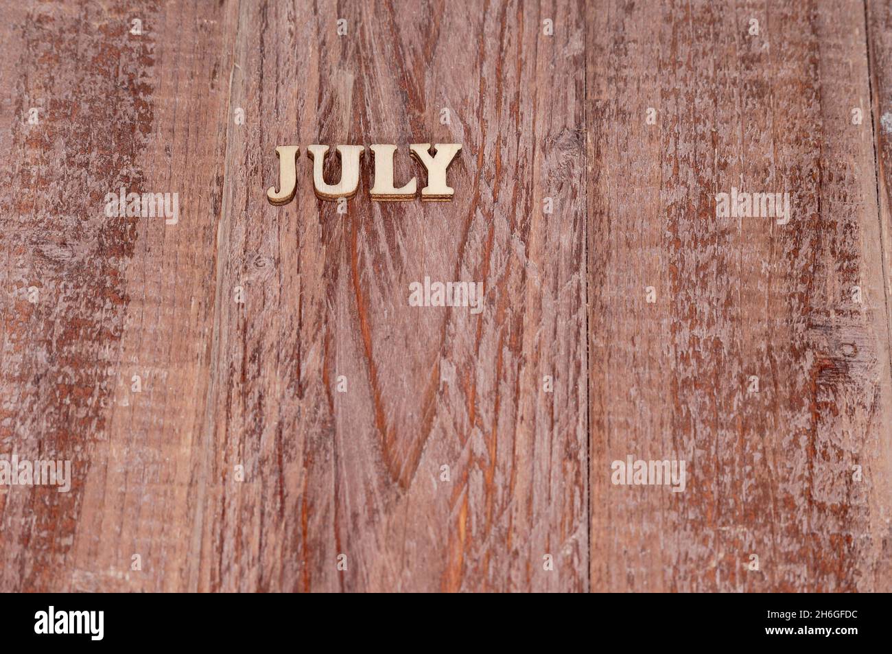 July month. Template for a calendar. The name of the months on a wooden ...