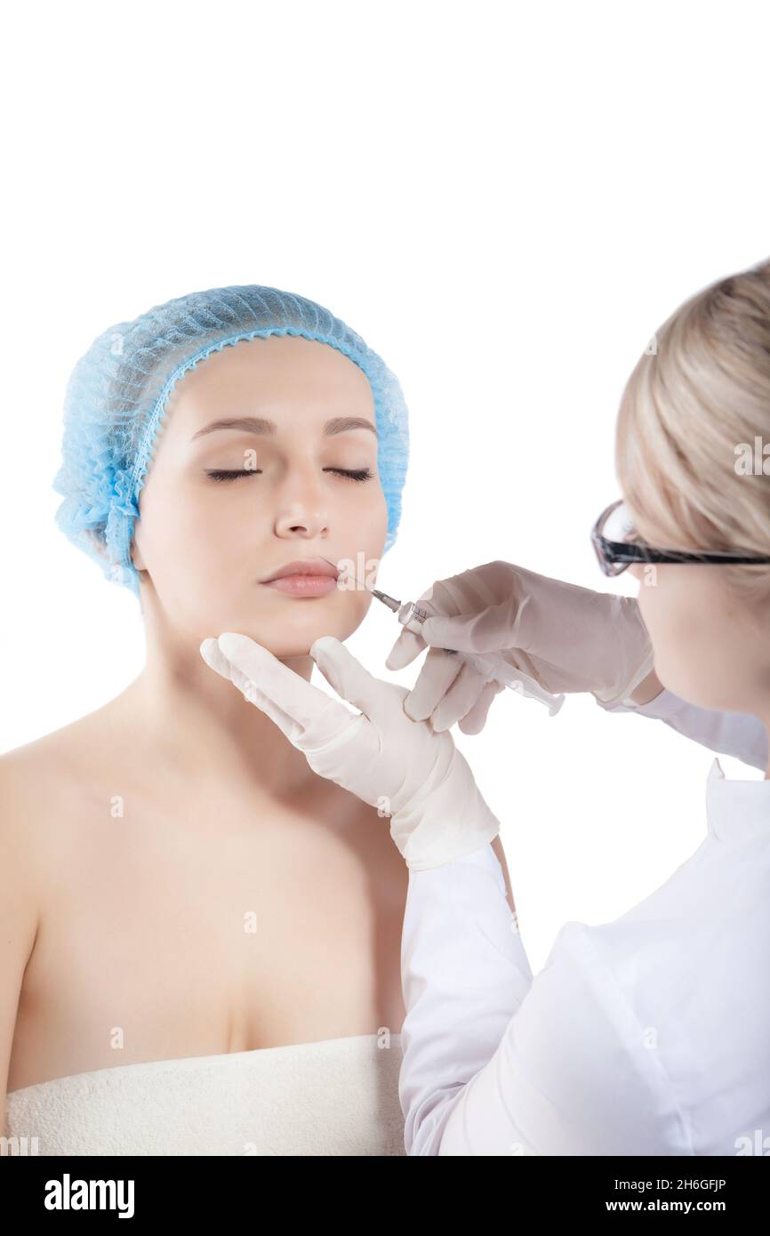 Beautiful woman gets an injection in her face isolated on white Stock ...