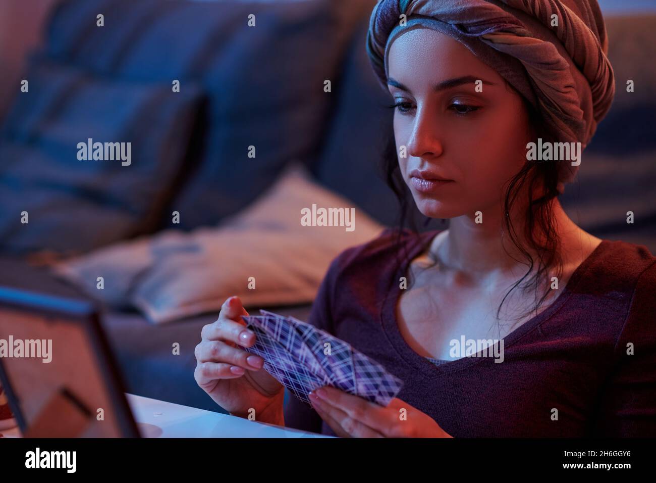 Serious lady conducting a magic ritual before the photo Stock Photo - Alamy