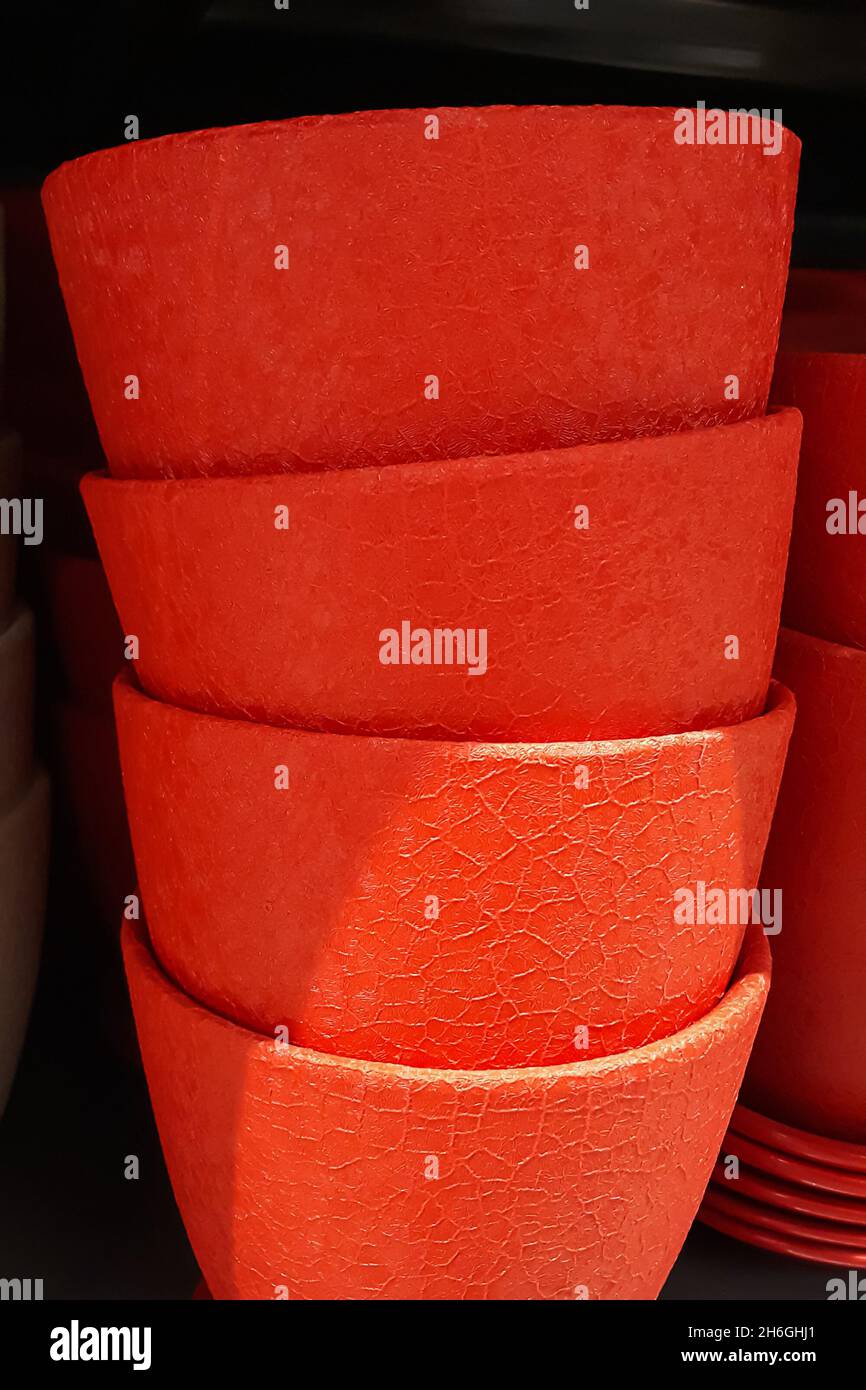 Sale of flower pots in store. Stack of ceramic planters for home plants ...