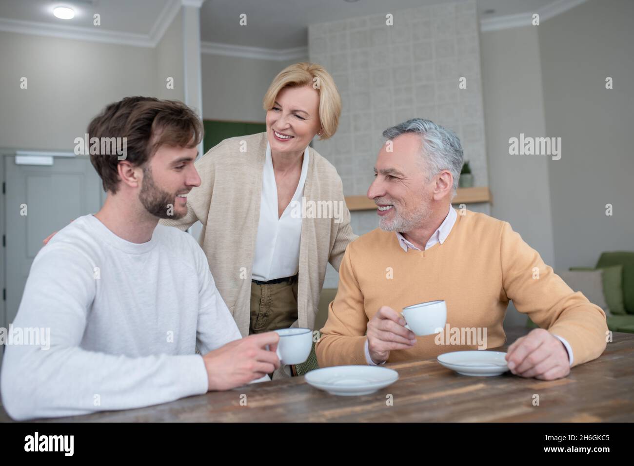 Parents happy to see their son, family looking happy Stock Photo - Alamy