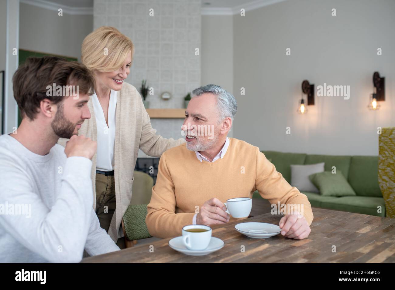 Parents happy to see their son, family looking happy Stock Photo - Alamy