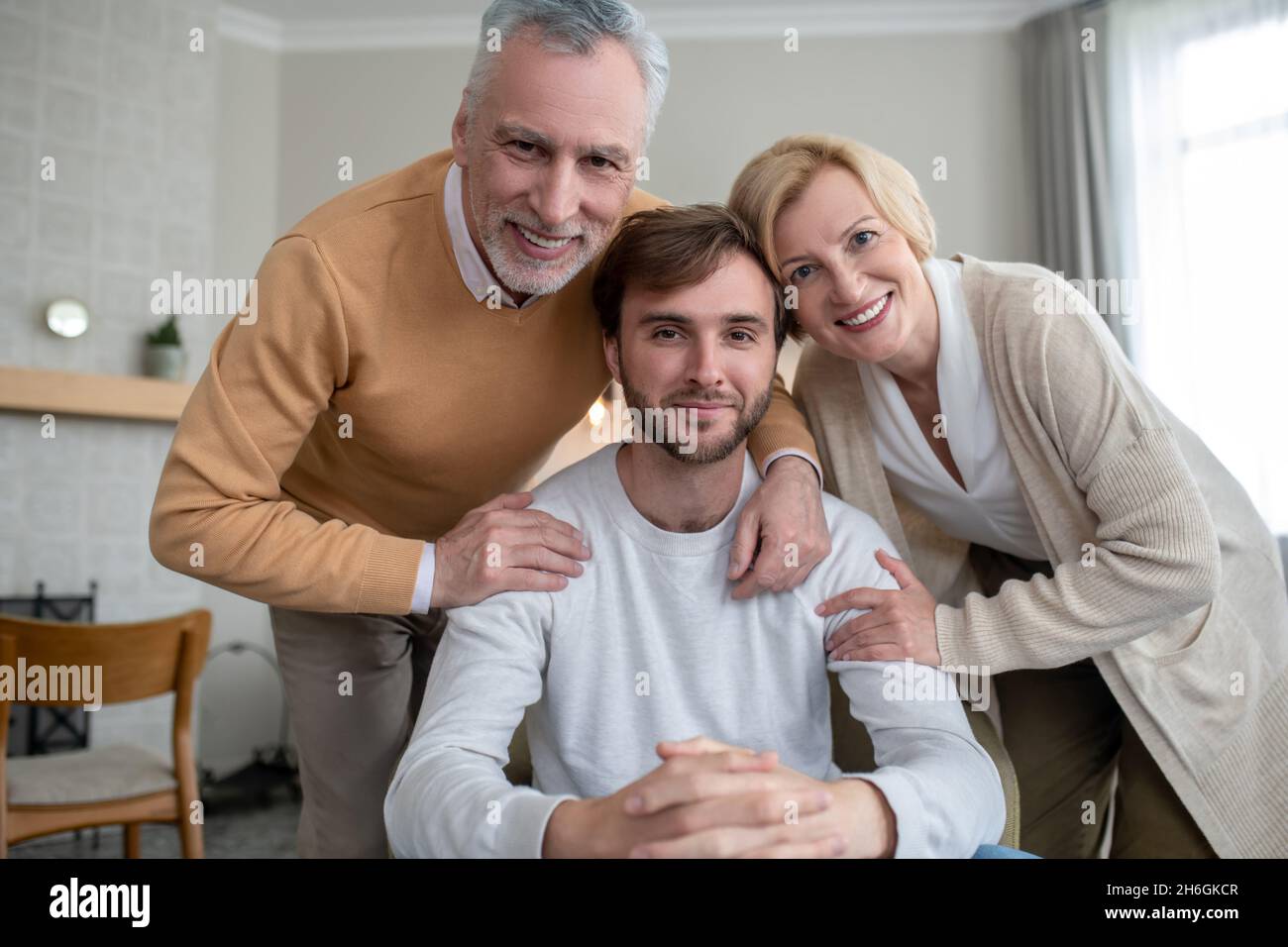 Parents happy to see their son, family looking happy Stock Photo - Alamy