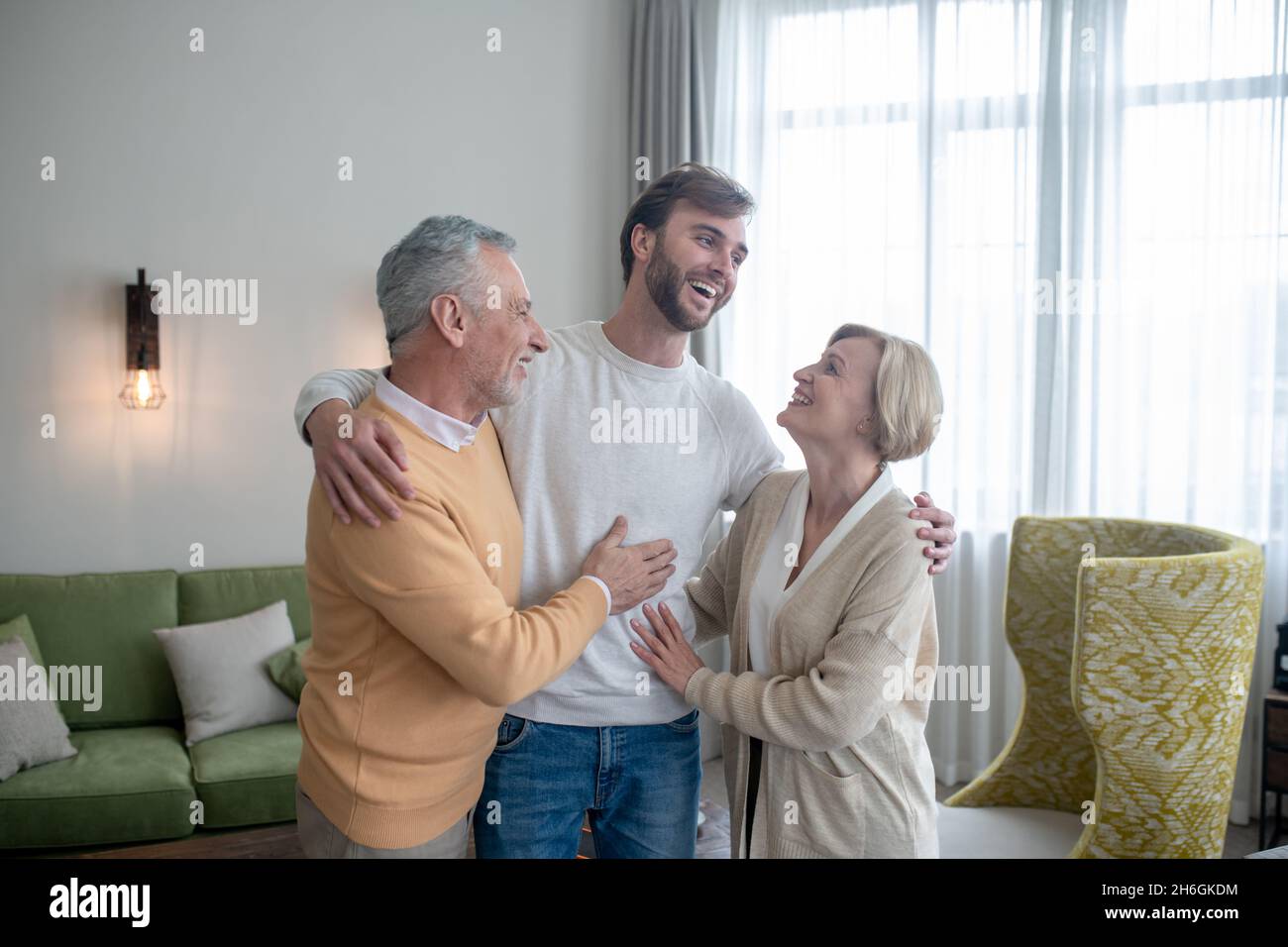 Parents happy to see their son, family looking happy Stock Photo - Alamy