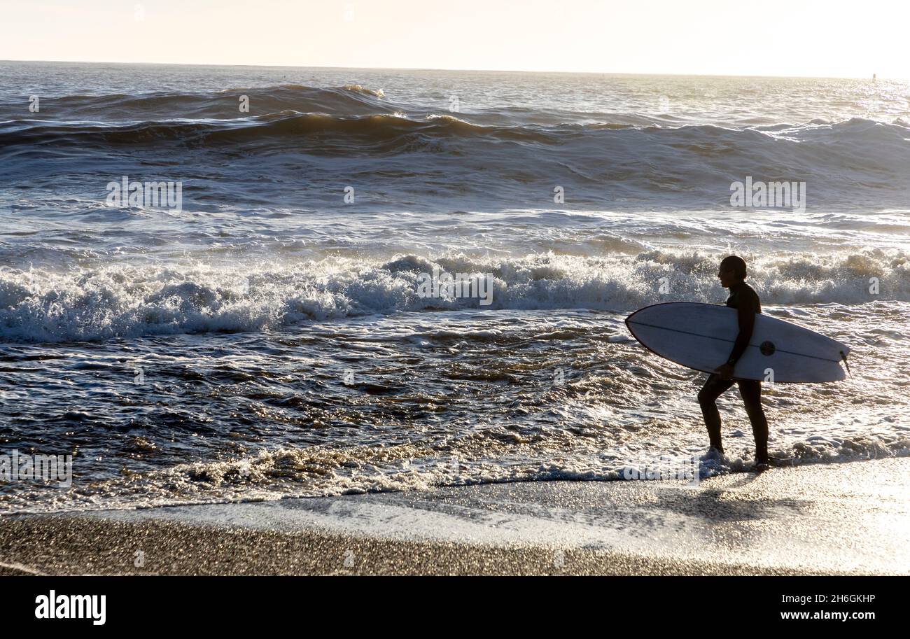 Surfer standing on the Rodeo Beach with his board. Marin Headlands ...