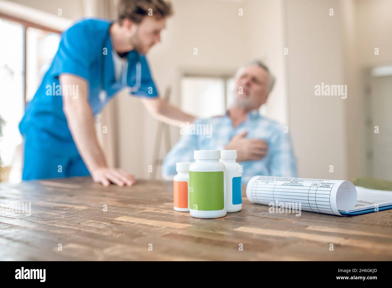 Doctor administering first aid to a mature man Stock Photo - Alamy