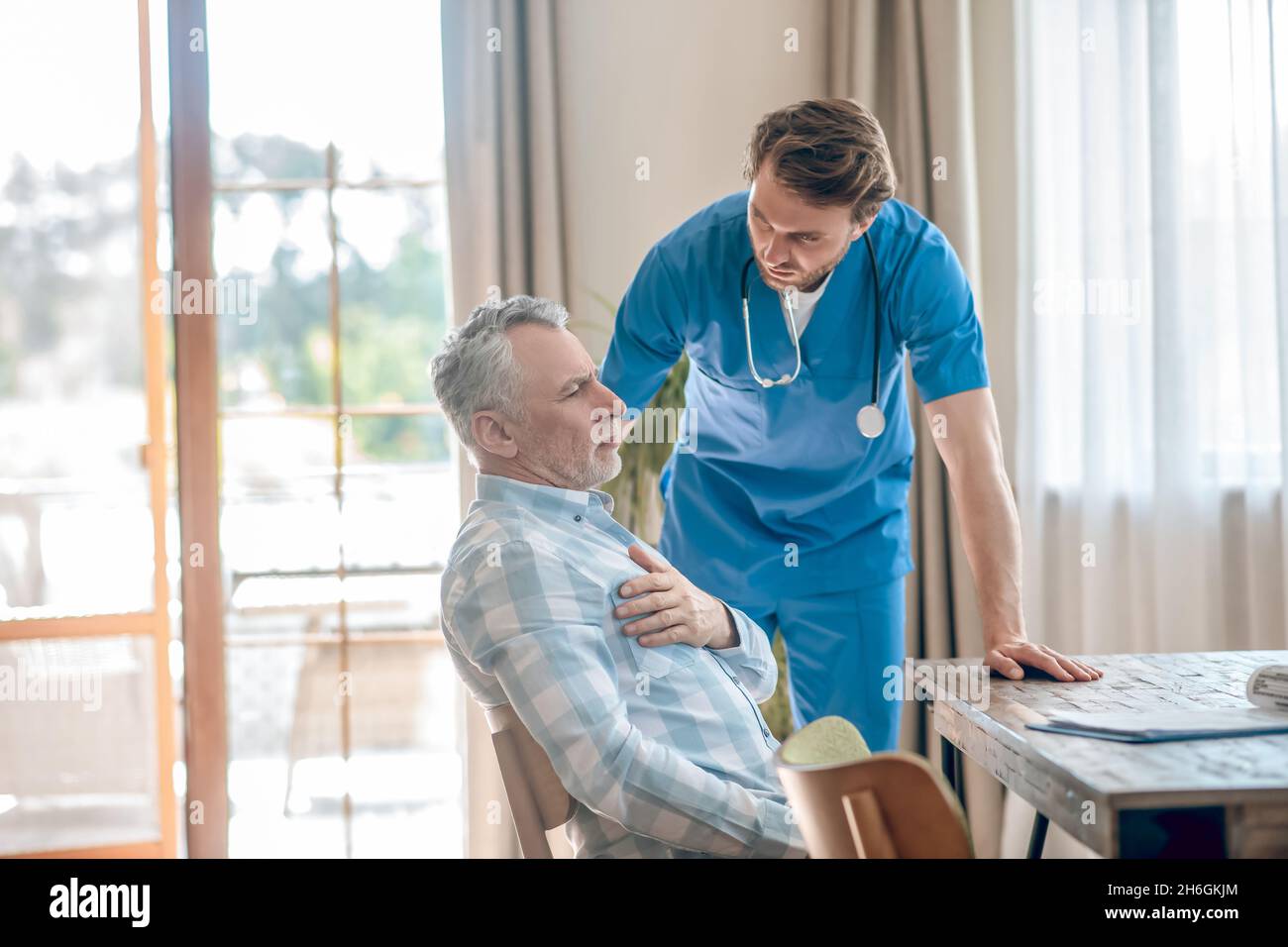 Physician taking care of a diseased middle-aged patient Stock Photo - Alamy
