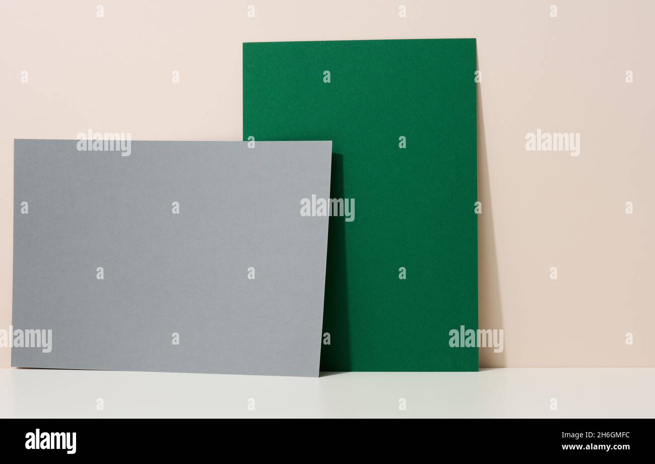 blank green and gray cardboard sheet of paper with shadow on white ...