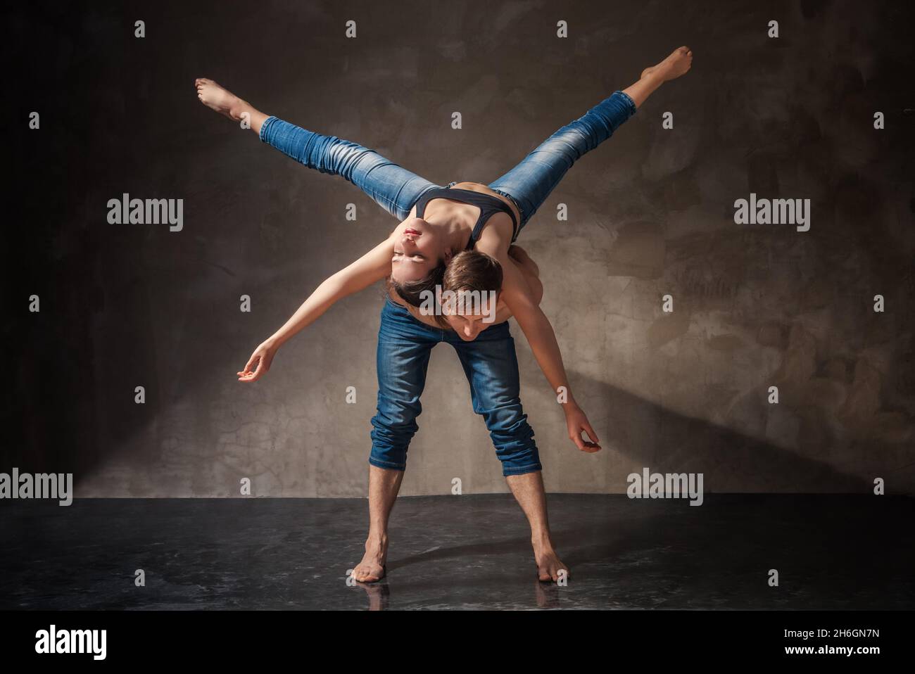Modern style Man and woman in passionate dance pose over gray back ...