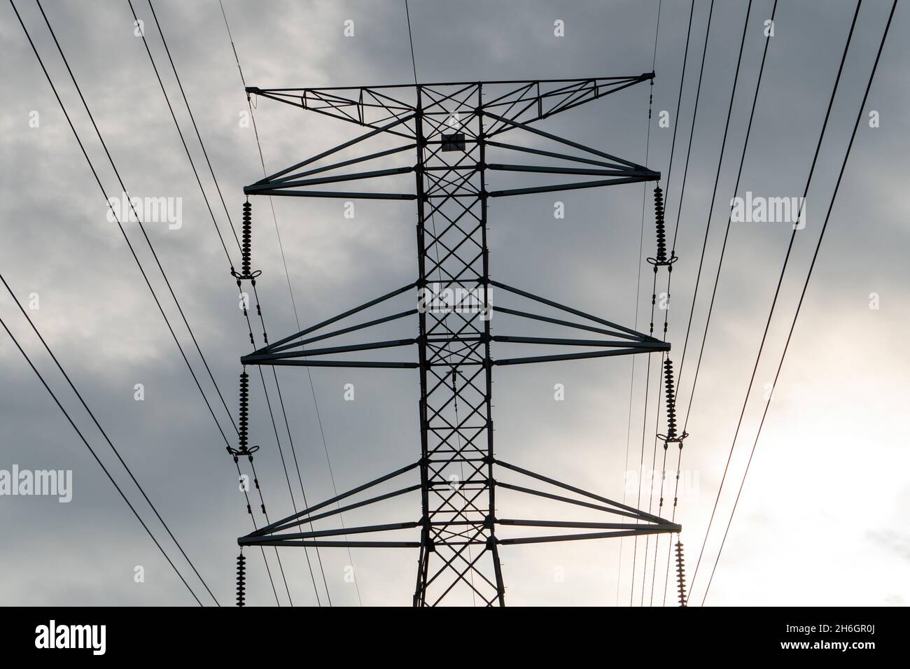 Low angle shot of electricity wires against a cloudy sky Stock Photo ...