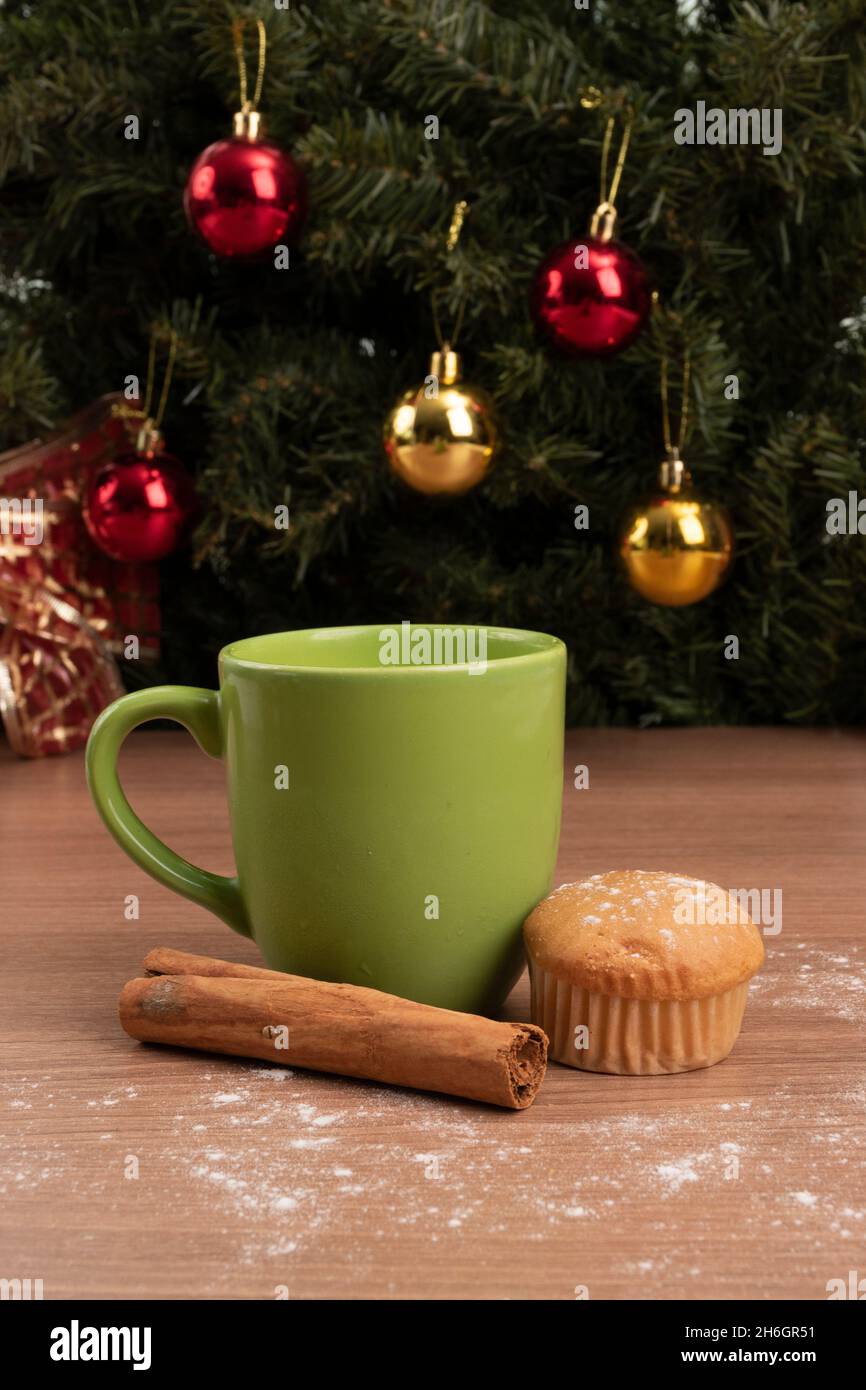 a cup with drink next to a cupcakes on a wooden table decorated with ...