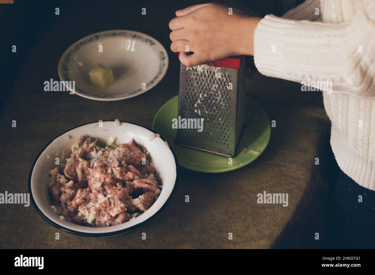 Cooking minced meat. Grating potatoes on a grater Stock Photo - Alamy