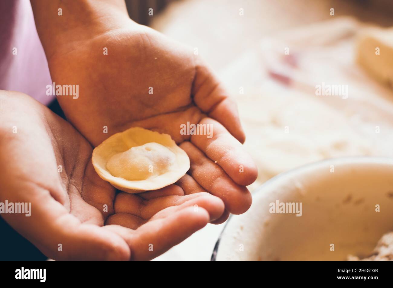 One dumpling in palms close-up on blurry background, copy space Stock ...
