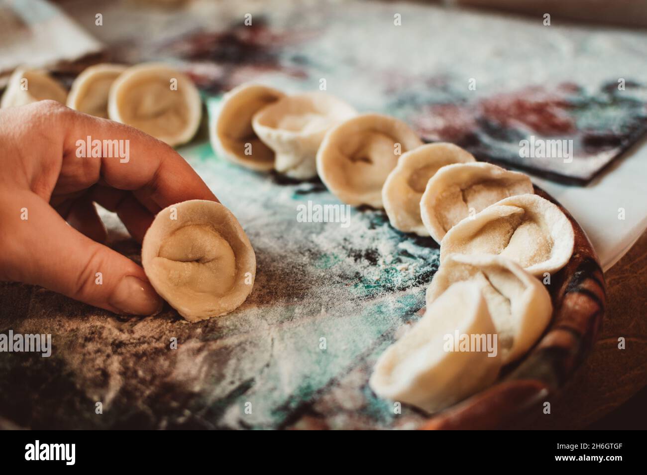Dumplings with meat in flour on a tray, close-up Stock Photo - Alamy