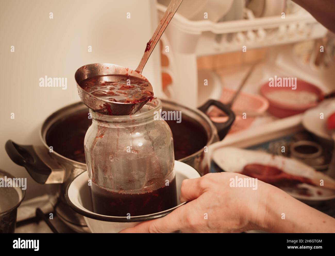 Woman cooking on gas stove in her kitchen hi-res stock photography and ...