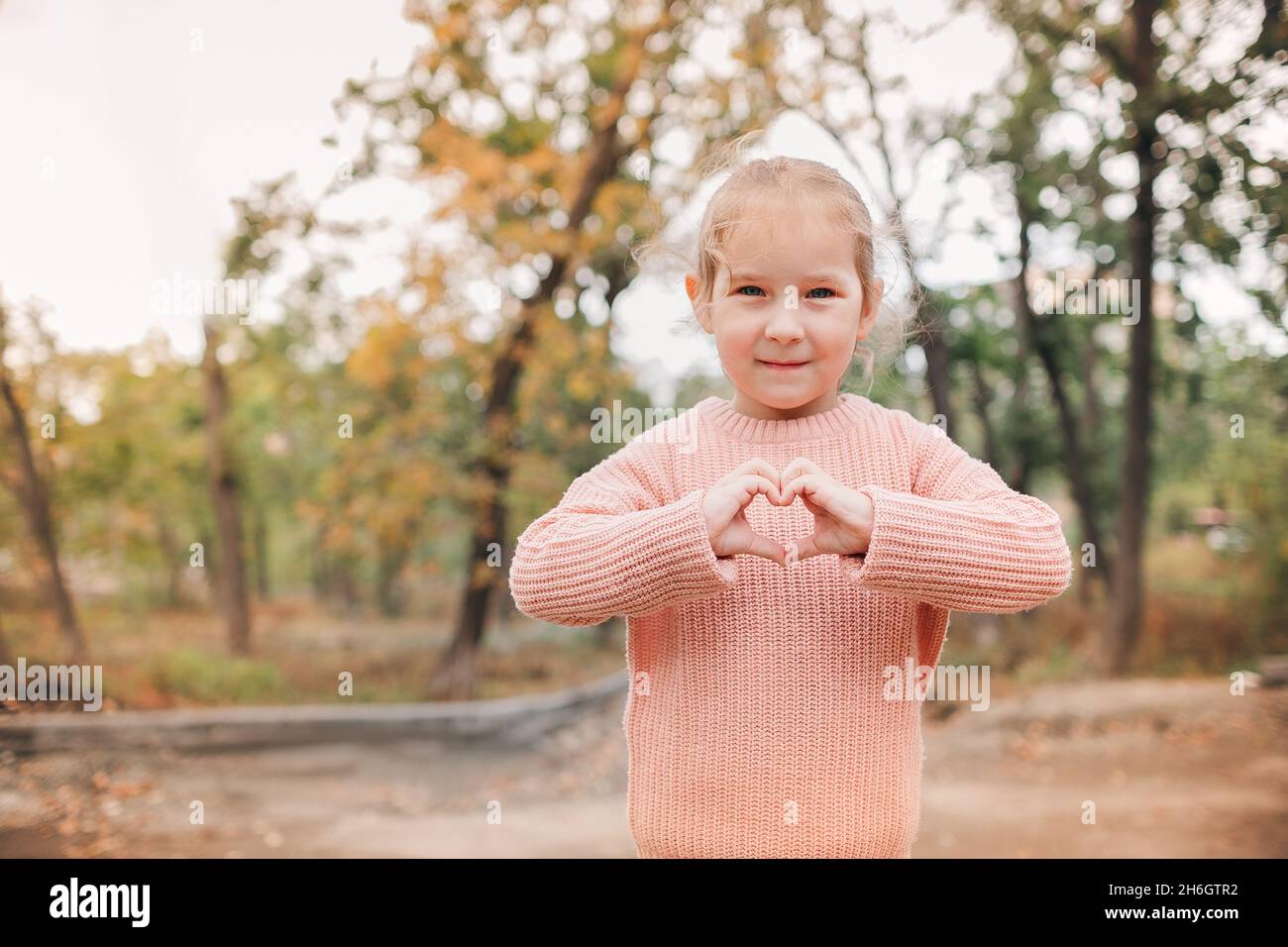 Little Girl Making Heart Sign With Her Hands Stock Photo - Alamy