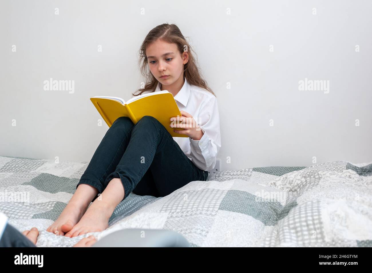School age girl sitting in her bedroom and doing school homework Stock ...