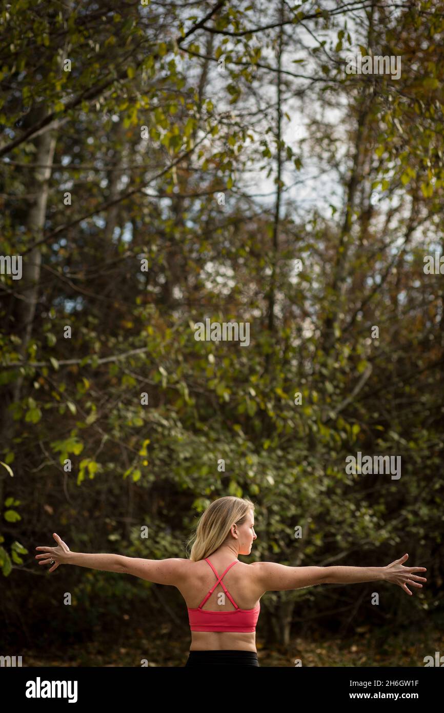Back view of strong woman in 30's with outstretched arms Stock Photo ...