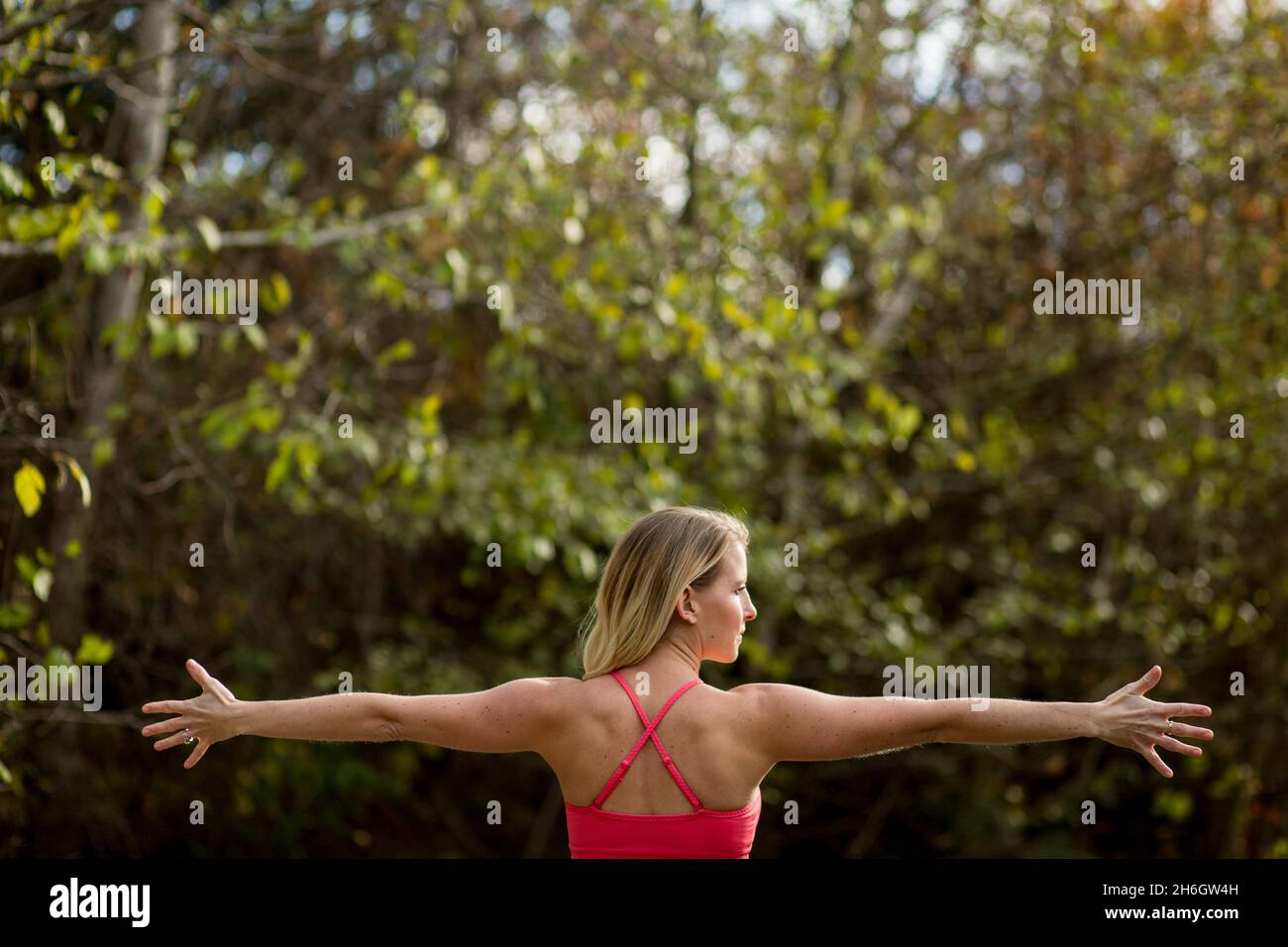 View from behind of woman with arms outstretched Stock Photo - Alamy
