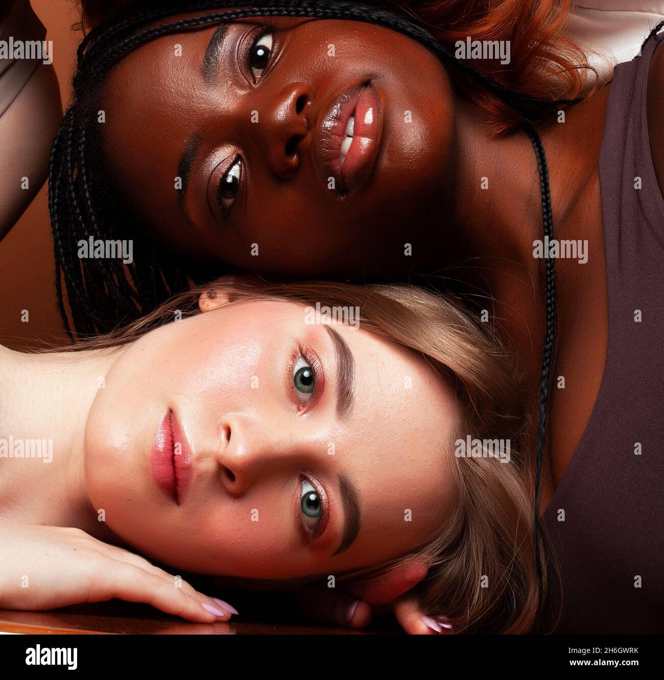 young pretty african and caucasian women posing cheerful together on ...