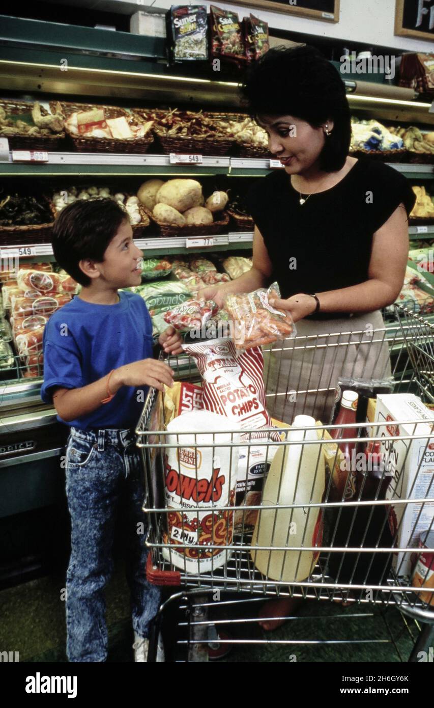 Austin Texas USA, 1989: Hispanic mother and 6-year-old son shopping in ...