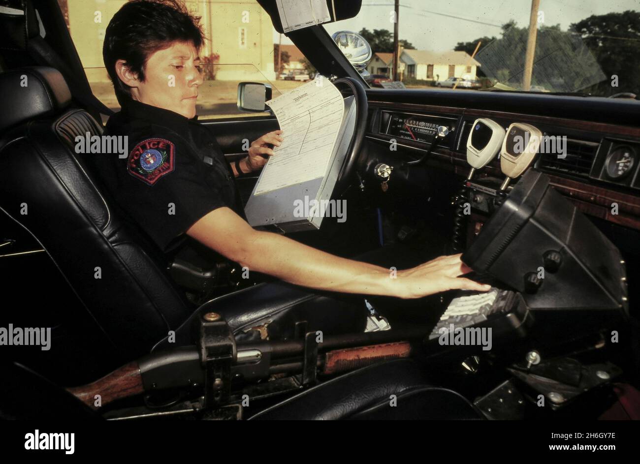 Austin Texas USA, circa 1994: Female Hispanic police officer working on ...