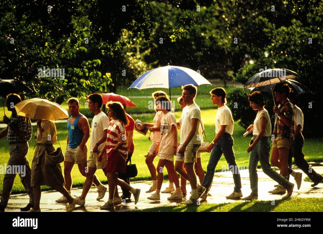Austin Texas USA, circa 1990: College students, some carrying umbrellas ...