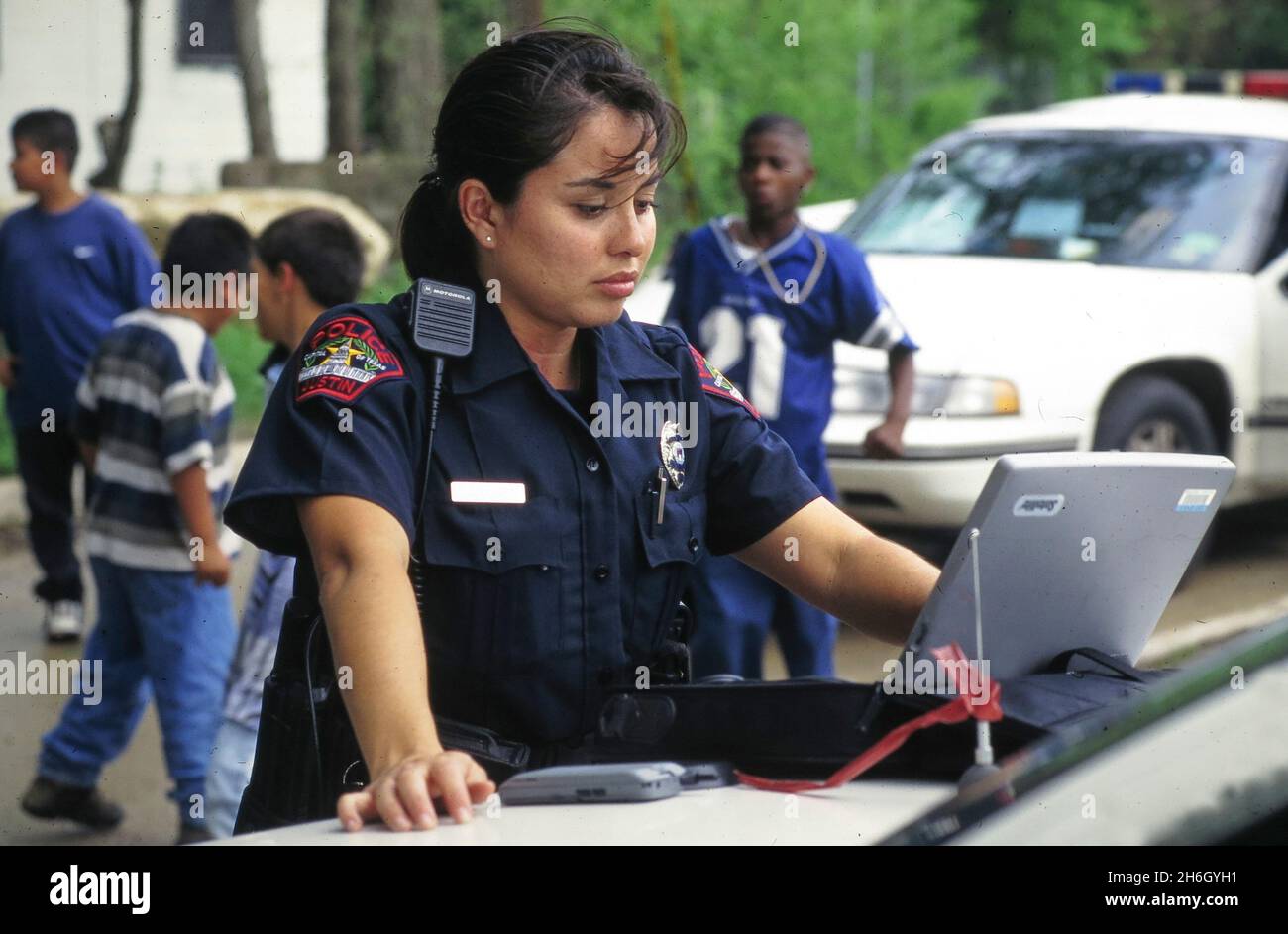 Austin Texas USA, circa 1995: Hispanic female police officer using a ...