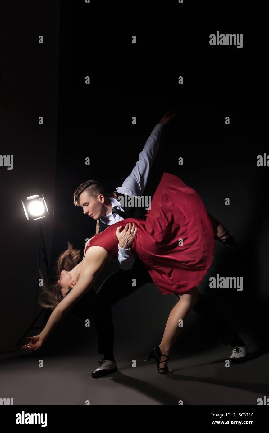 Man and woman in the most romantic dance tango over dark background ...