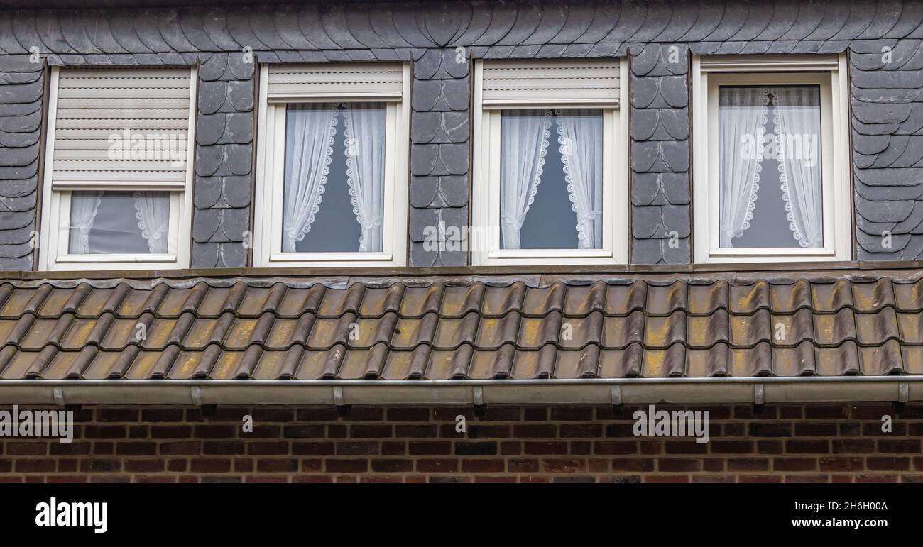 Row of glass windows with curtains on an old facade building Stock ...